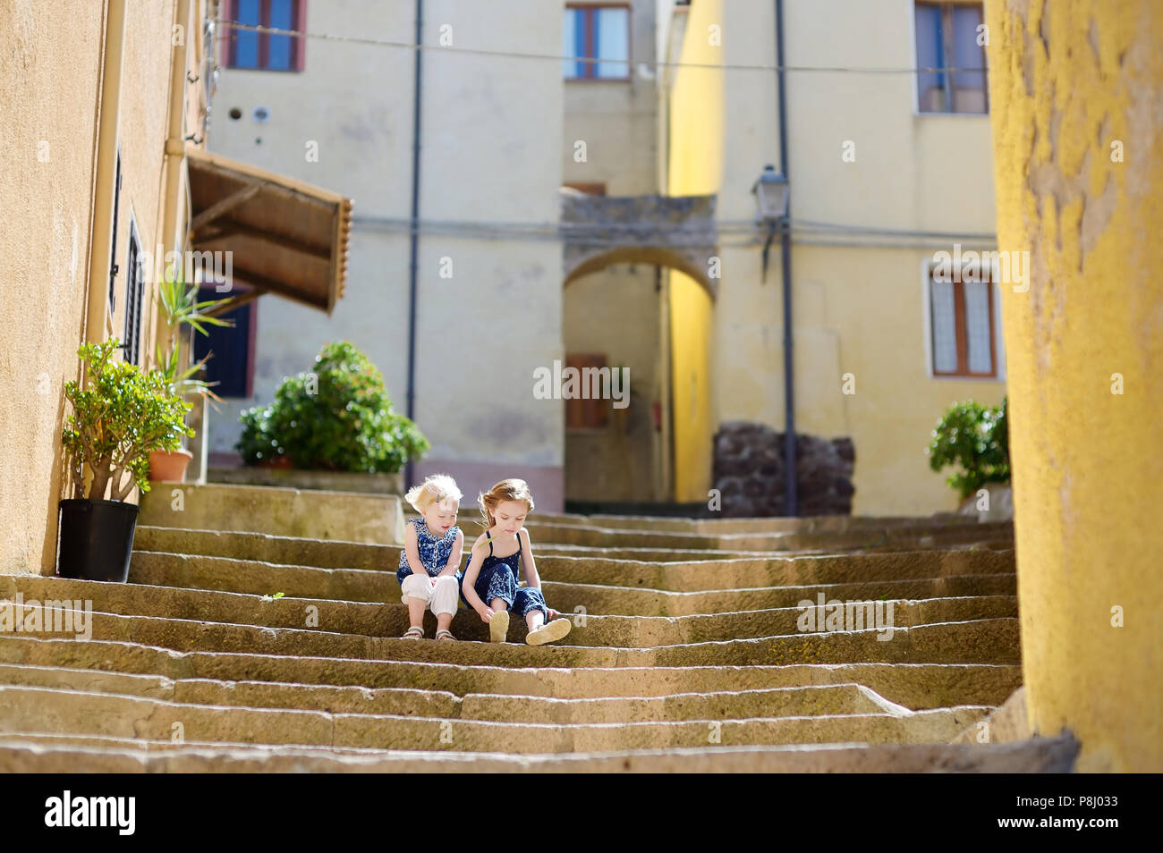 Two sisters sitting on stairs hi-res stock photography and images - Alamy