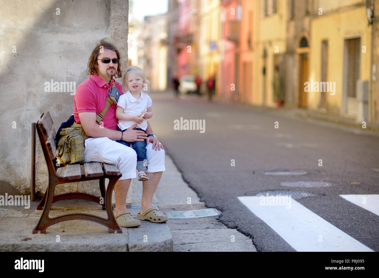 Father and his daughter on a street of typical italian town Stock Photo ...