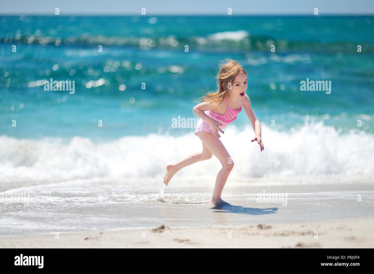 Child jumping over waves hi-res stock photography and images - Alamy