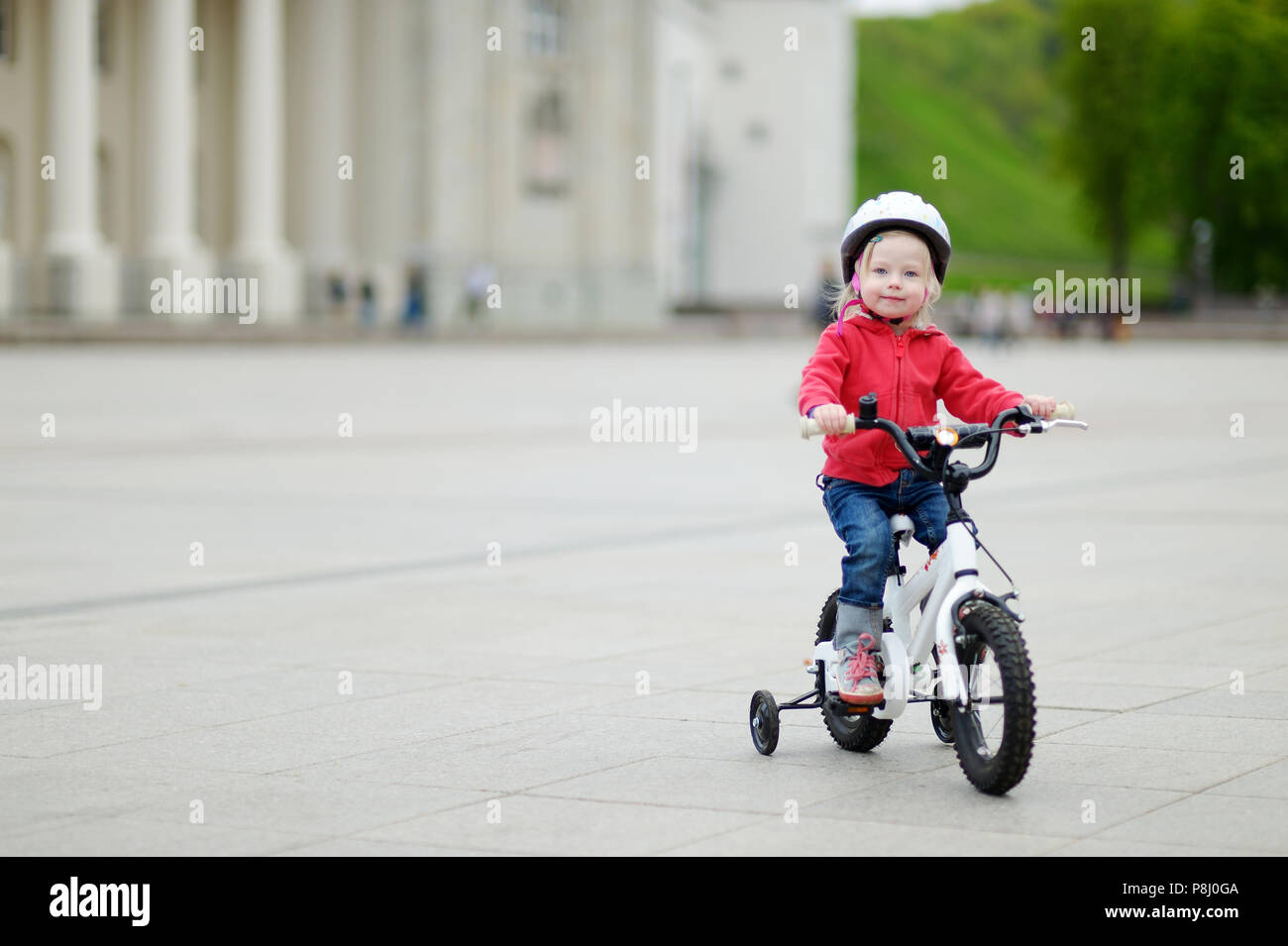 Adorable toddler girl riding her first bike Stock Photo - Alamy
