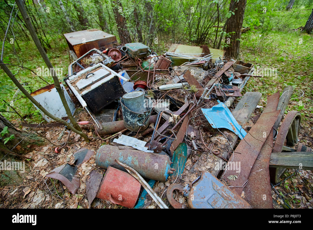 Dump old metal objects in the woods, rusty scrap metal. Environmental ...