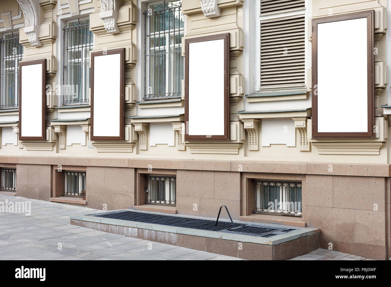 Blank posters on the wall. Isolated with clipping path Stock Photo - Alamy