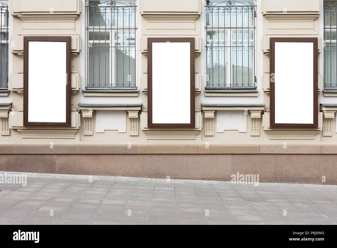 Blank posters on the wall. Isolated with clipping path Stock Photo - Alamy