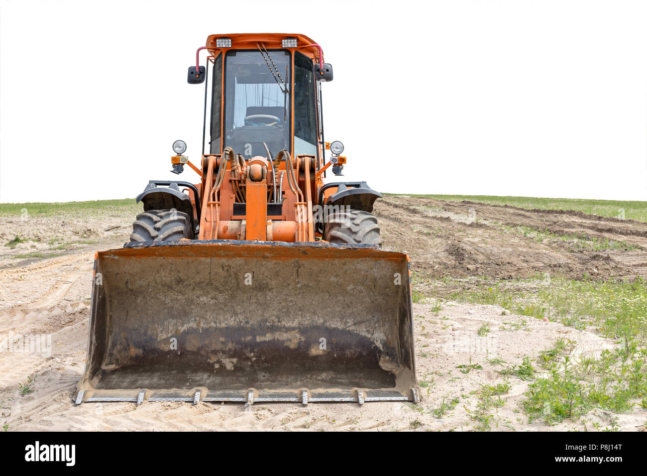 orange wheel loader on new construction site. front view Stock Photo ...