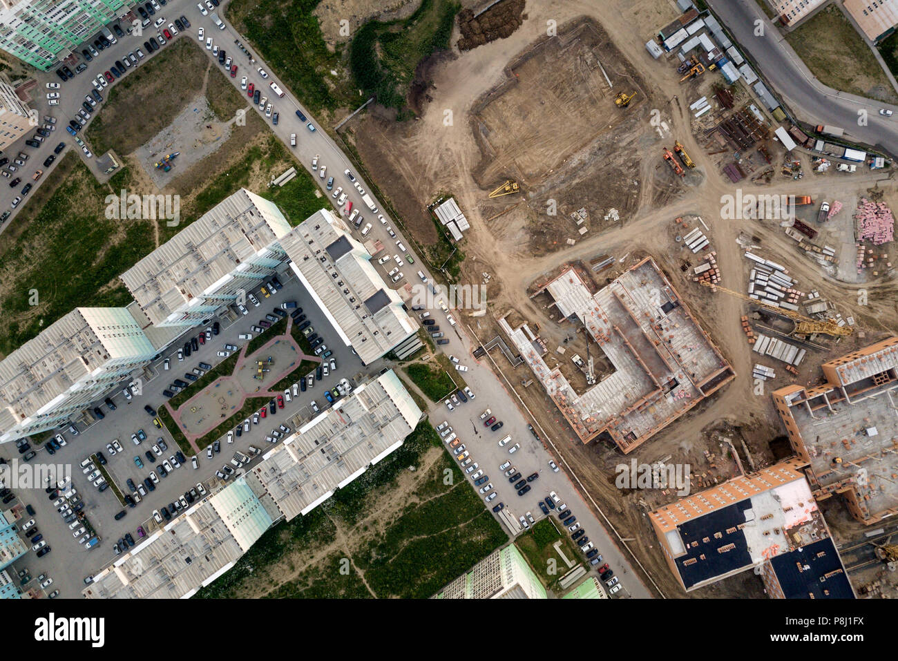 Aerial city view with crossroads, roads, houses, buildings, parks ...