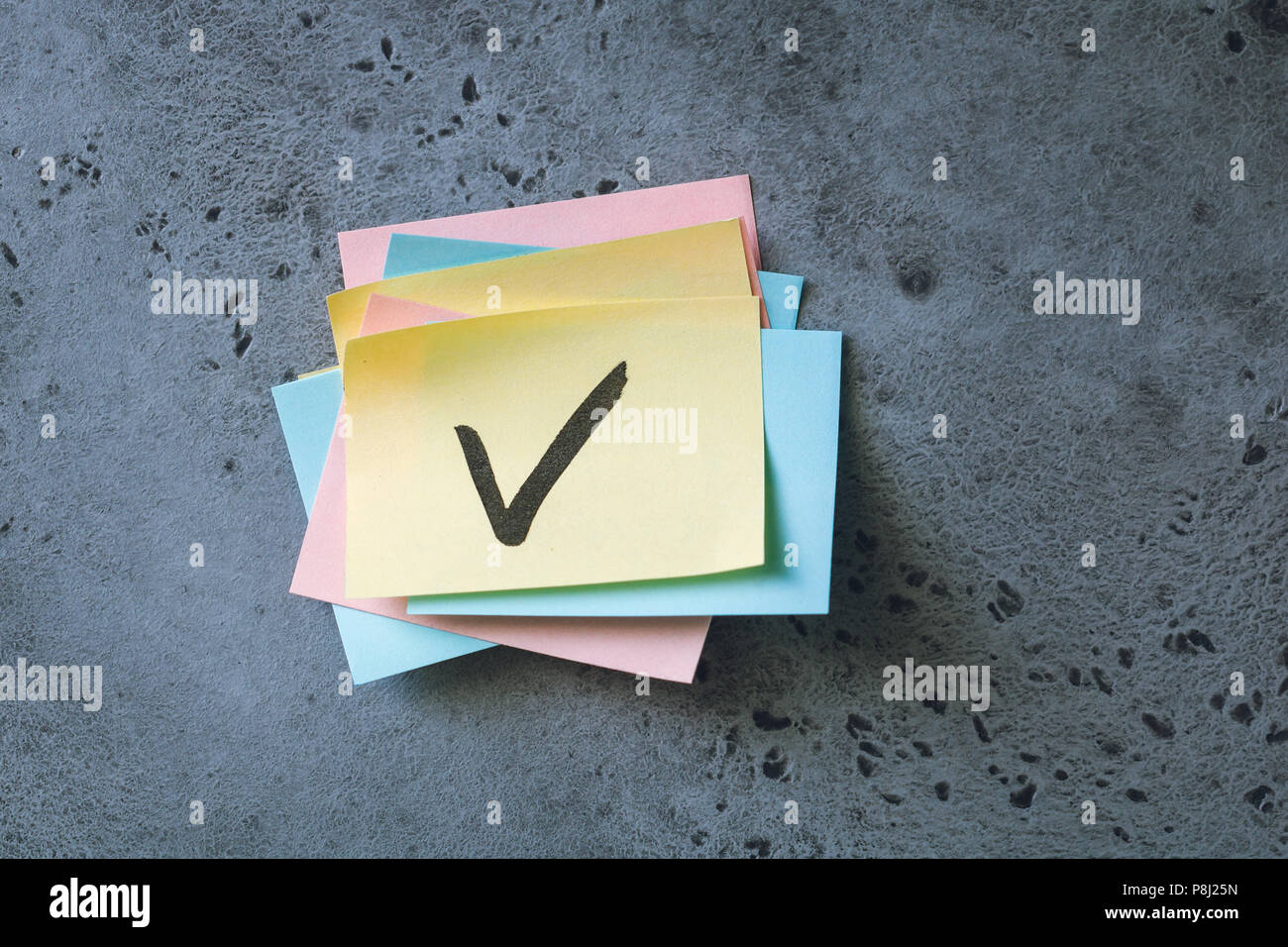 Check mark on a sticky note. Pastel colors Stock Photo - Alamy
