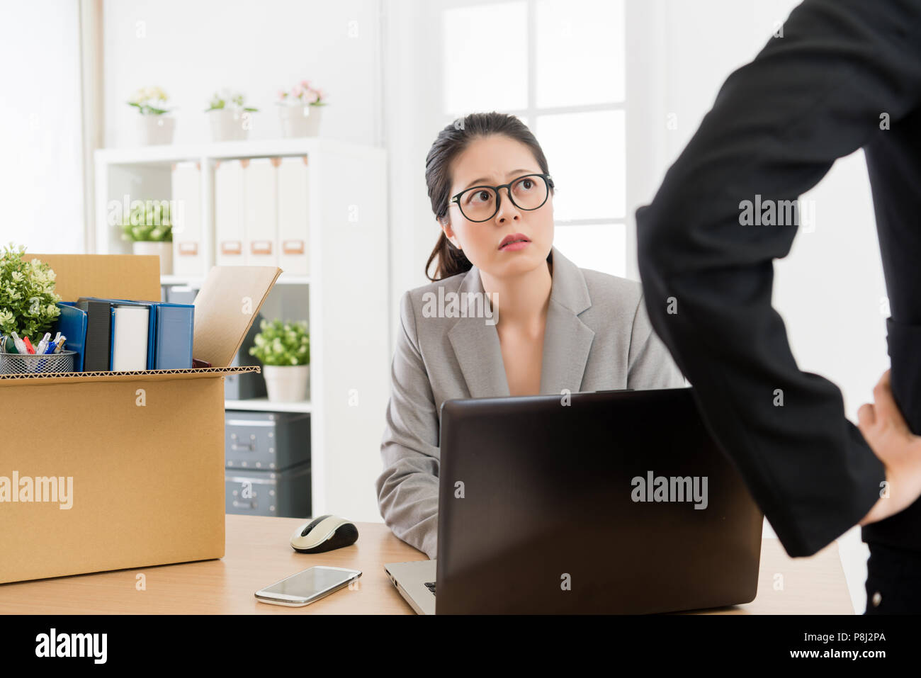 Strict supervisor standing in the front of the computer and oversight ...