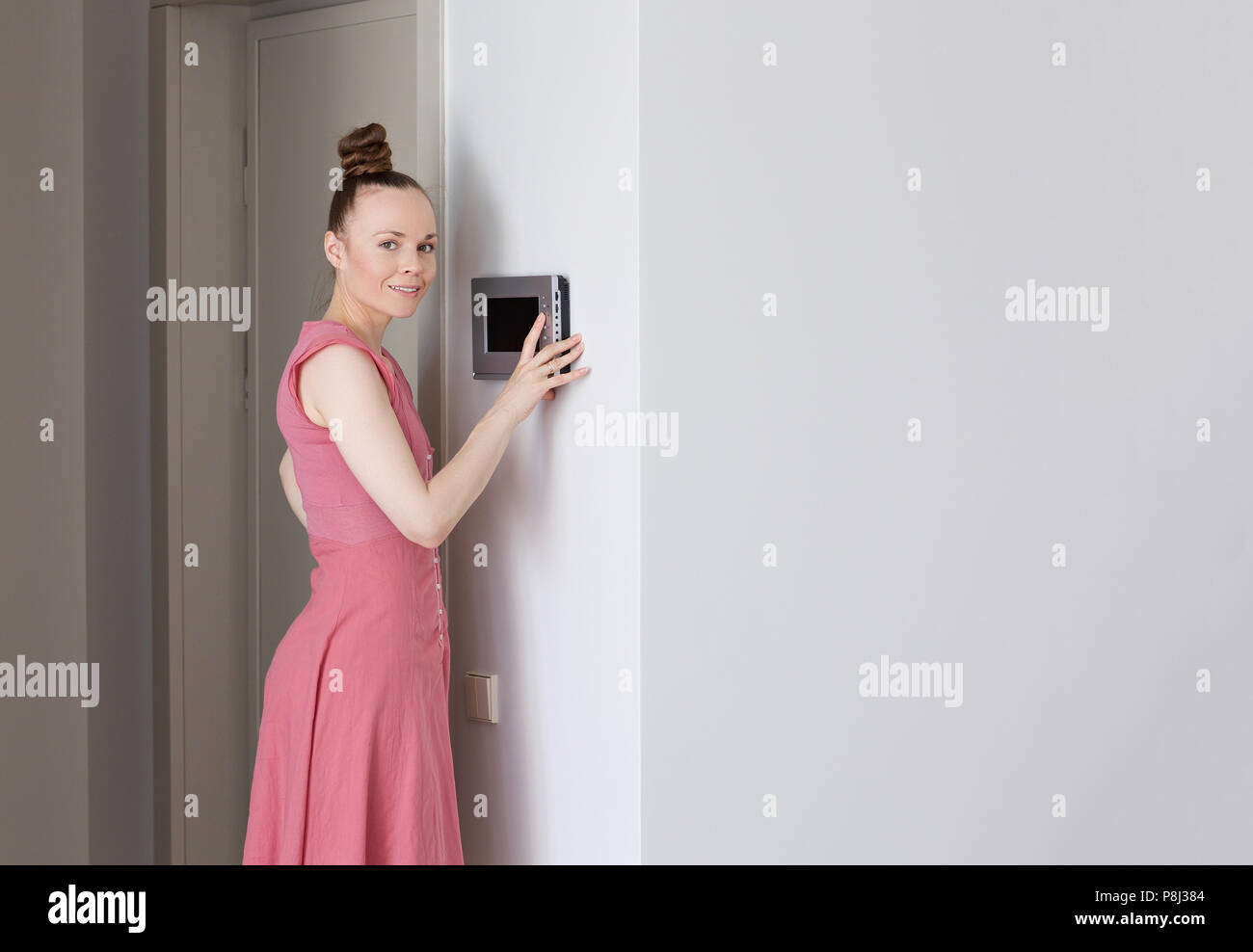 Young lady between 30 and 40 years old and intercom Stock Photo - Alamy