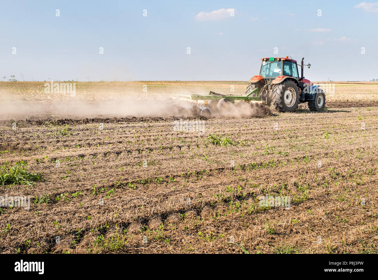 Tractor preparing land for sowing Stock Photo - Alamy