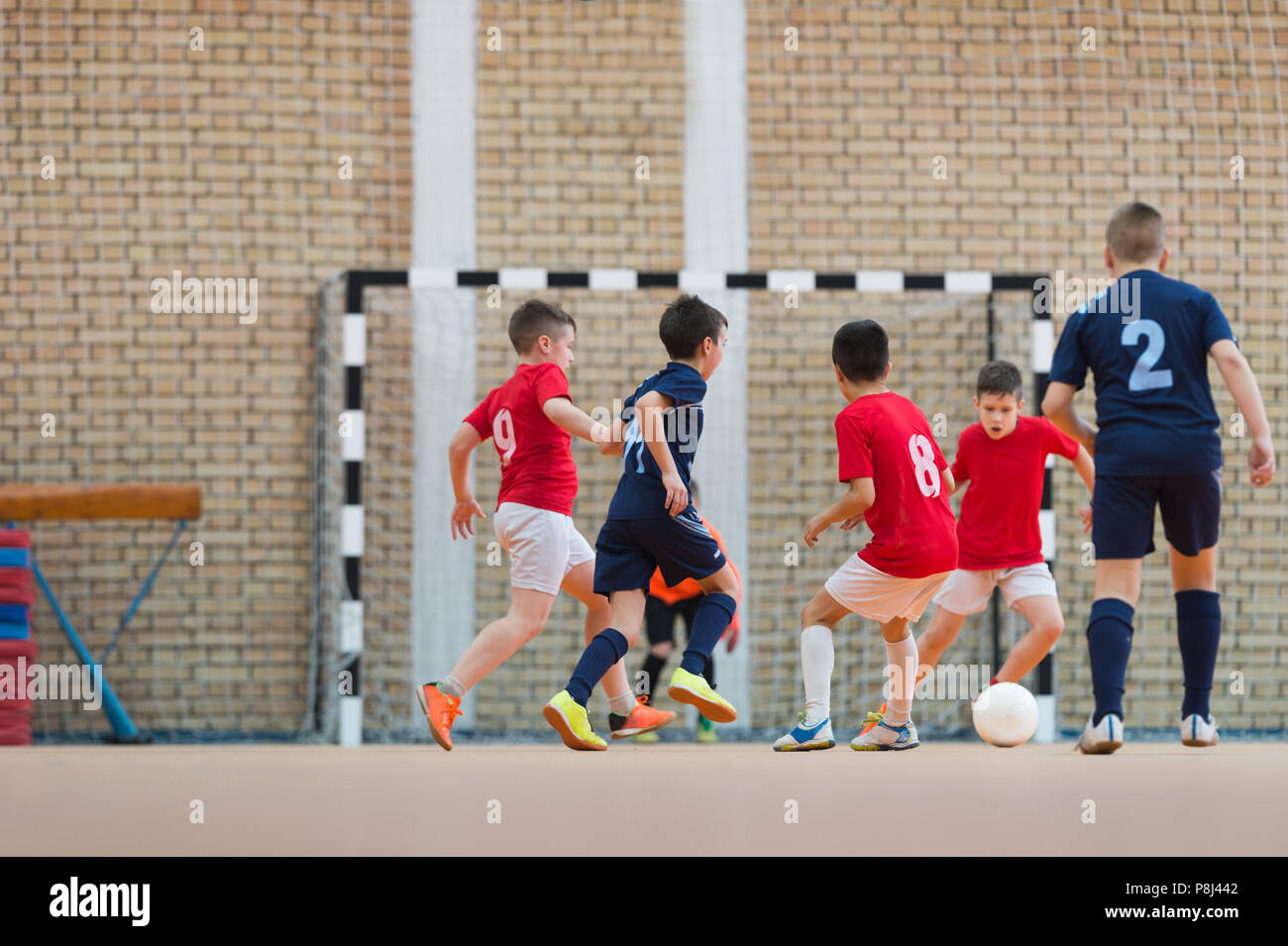 Boy kicking soccer ball at net hi-res stock photography and images - Alamy