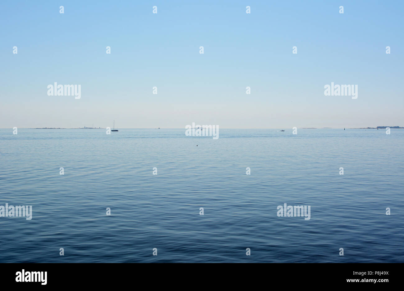 Calm blue waters and clear sky above in the Gulf of Finland. Small ...