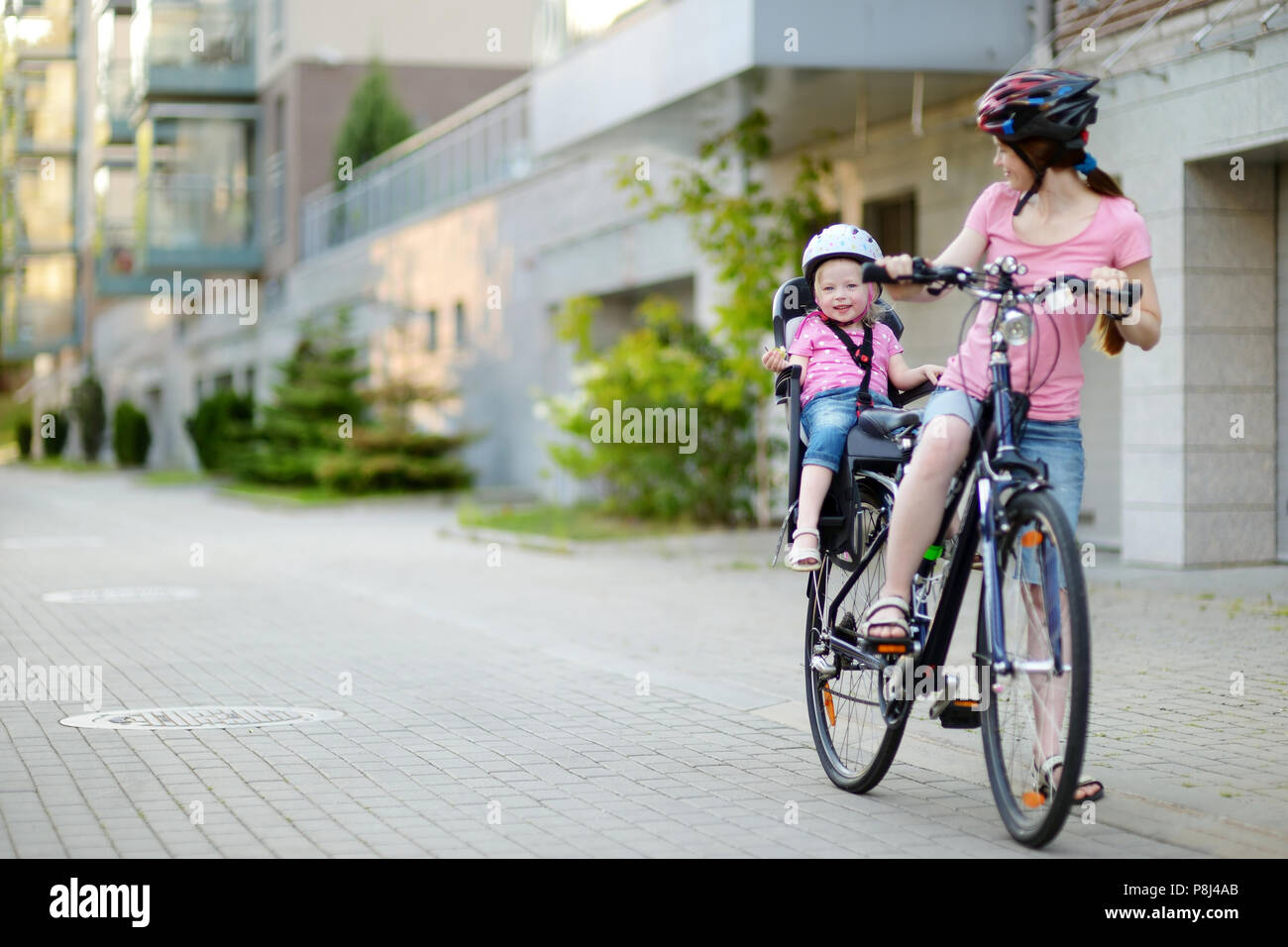 Parent riding a bike with a toddler hi-res stock photography and images ...