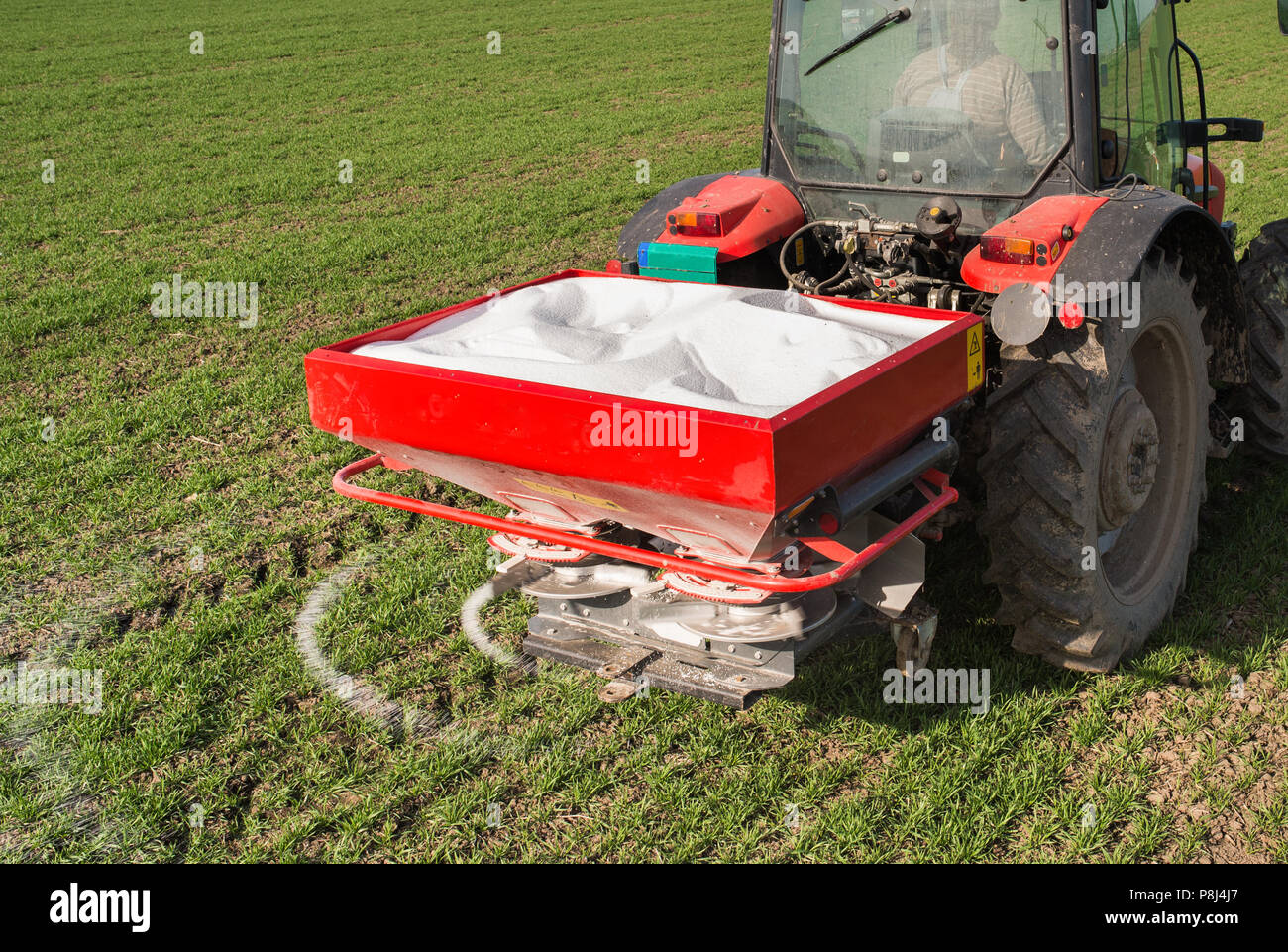tractor fertilizing in wheat field Stock Photo - Alamy