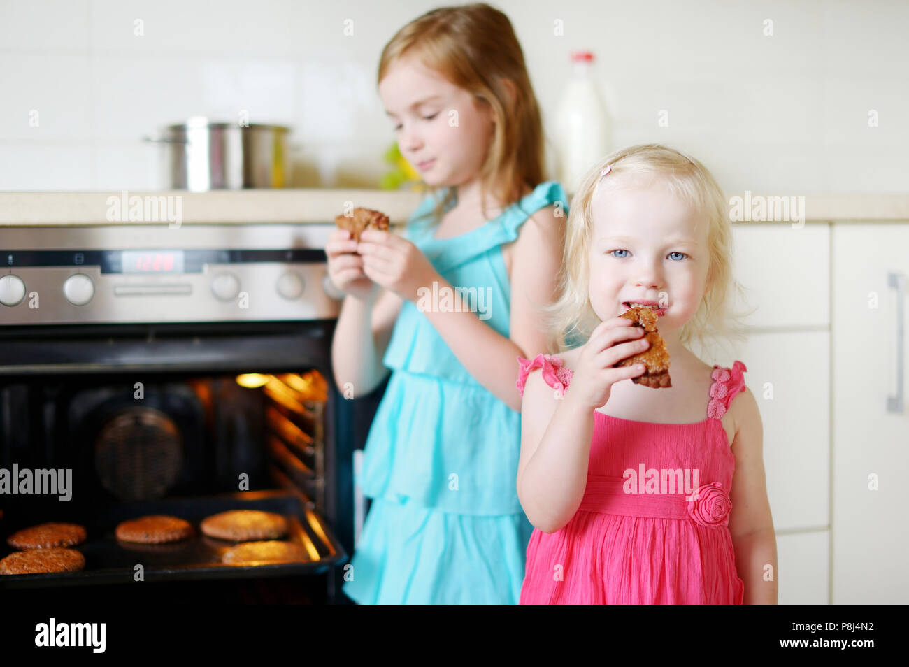 Two sisters cooking together hi-res stock photography and images - Alamy