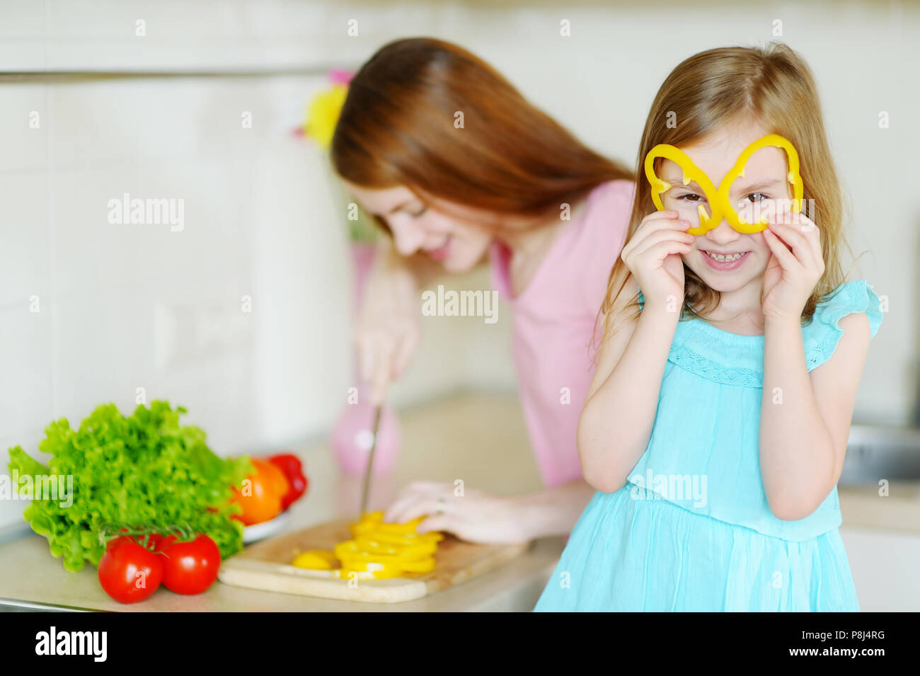 Mother and daughter cooking dinner in a kitchen Stock Photo - Alamy