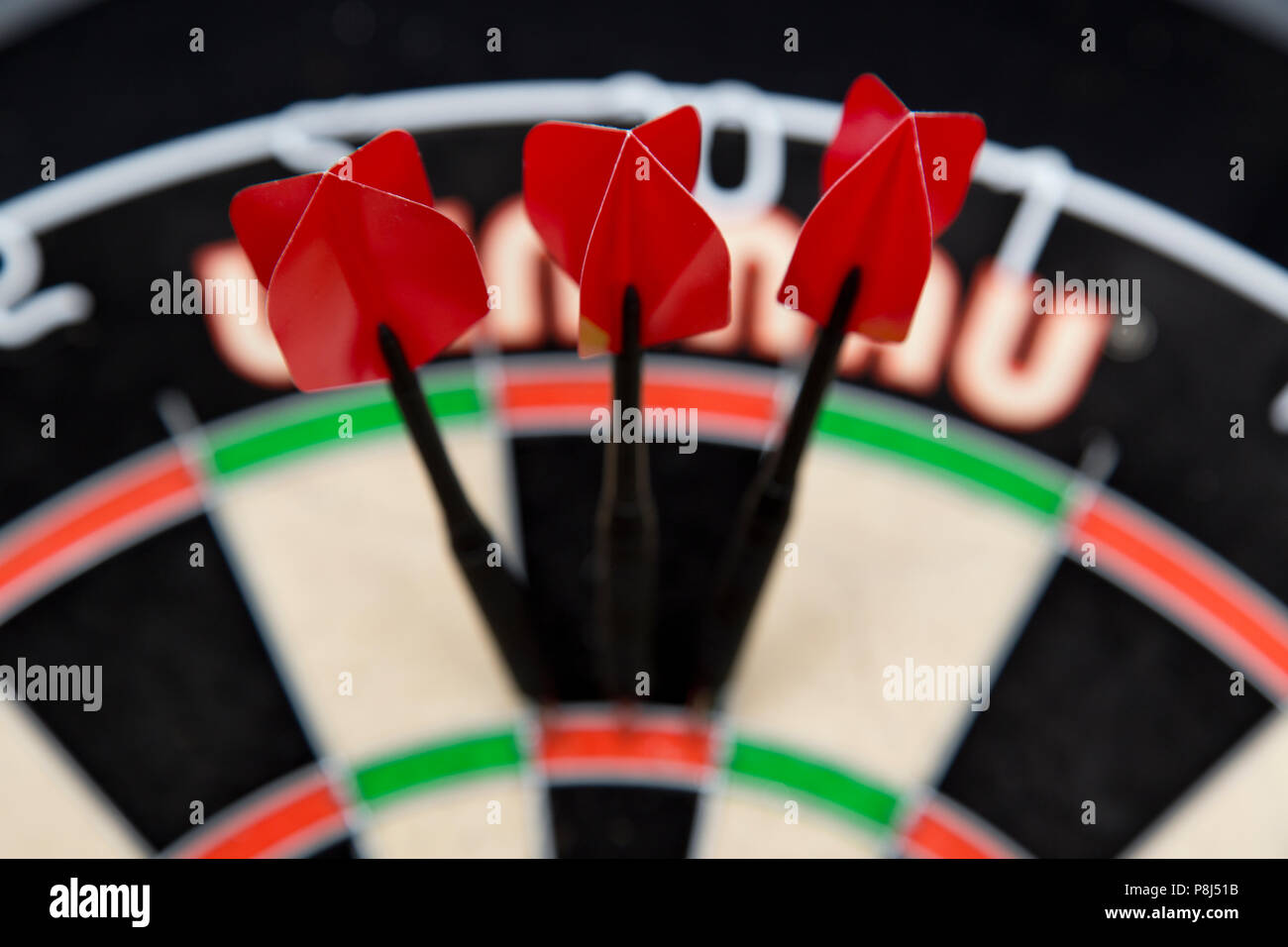 three darts in a dartboard Stock Photo - Alamy