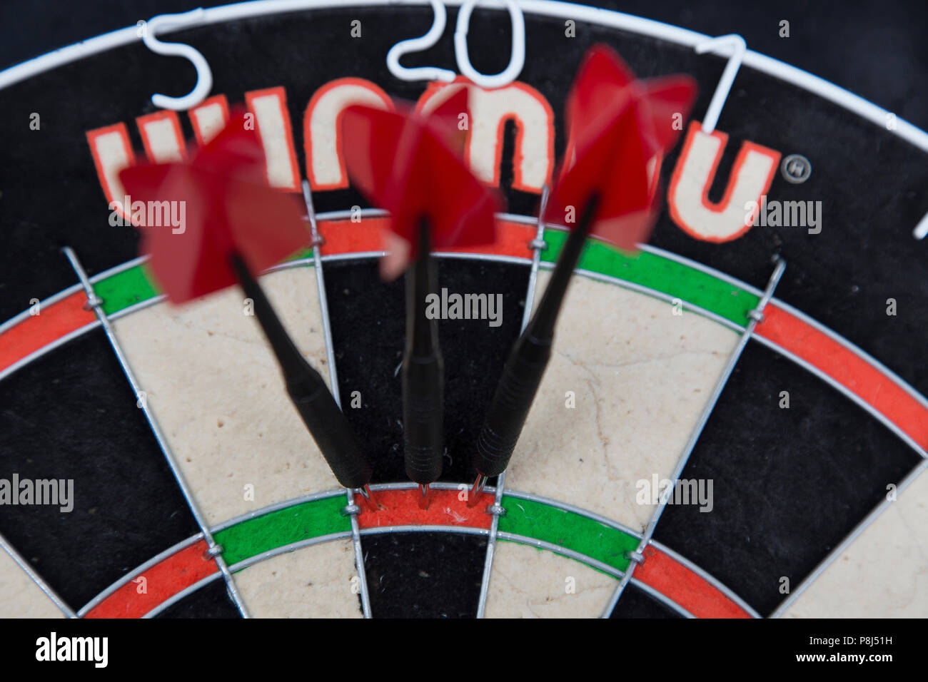 three darts in a dartboard Stock Photo - Alamy