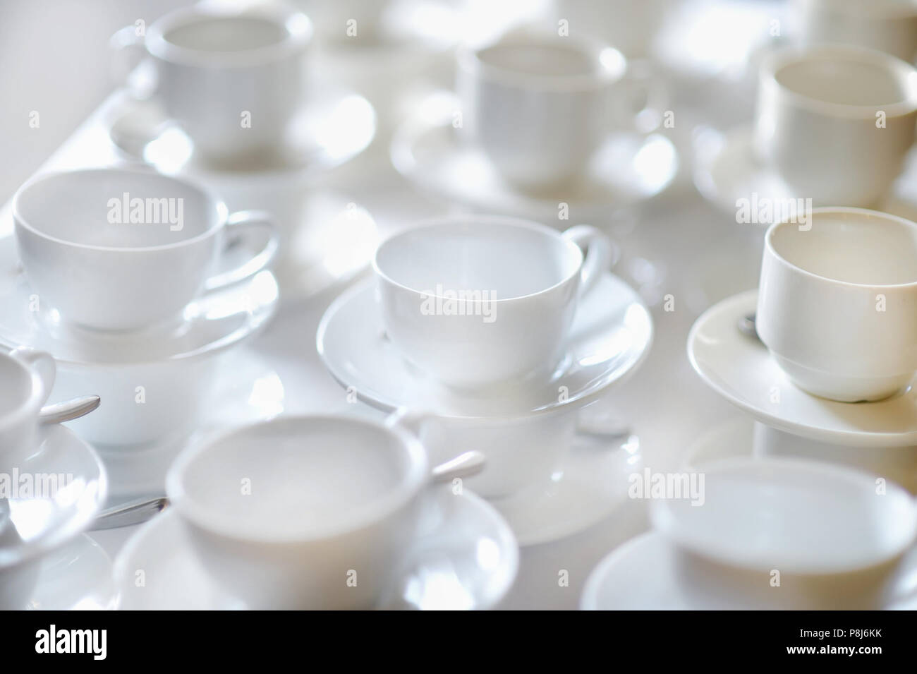 Many rows of pure white coffee cups and saucers Stock Photo - Alamy