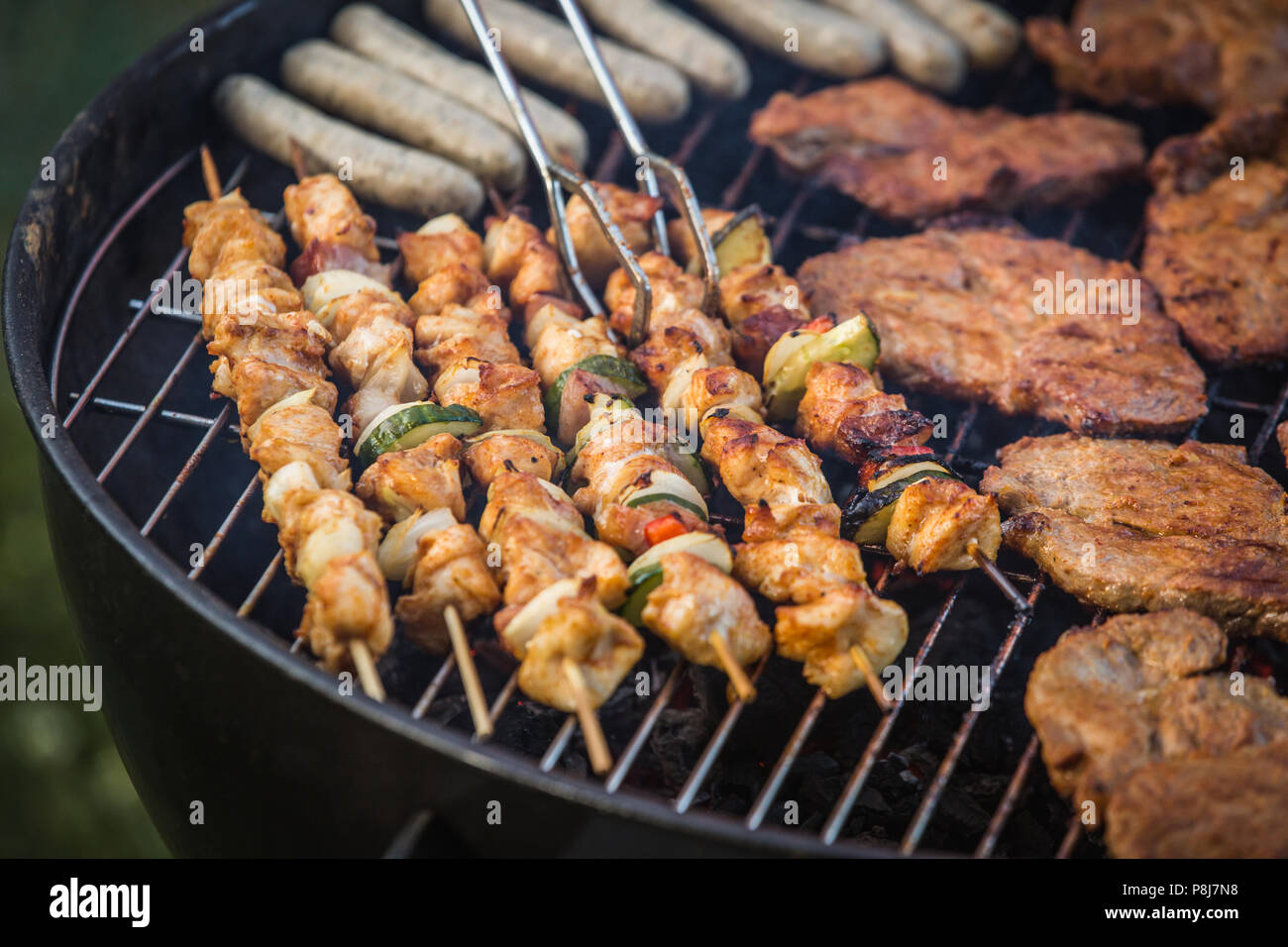 Grilling shashlik and meat on barbecue grill Stock Photo - Alamy