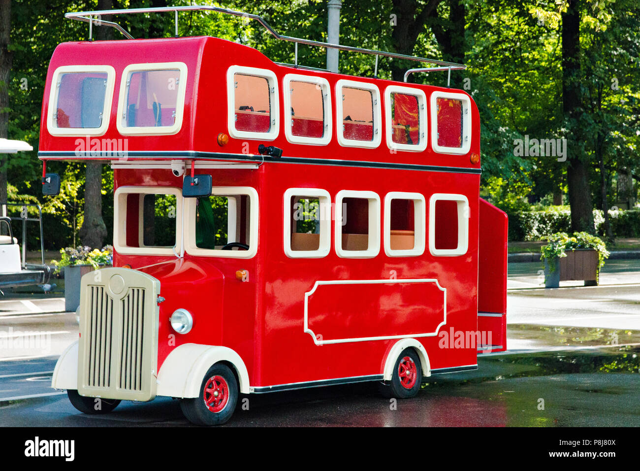 the red double-decker bus in city park Stock Photo - Alamy