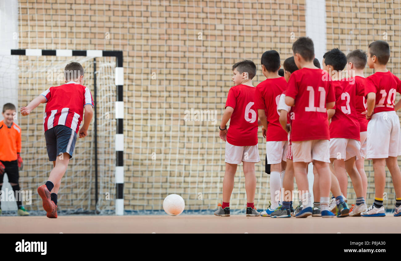 Boy kicking soccer ball at net hi-res stock photography and images - Alamy