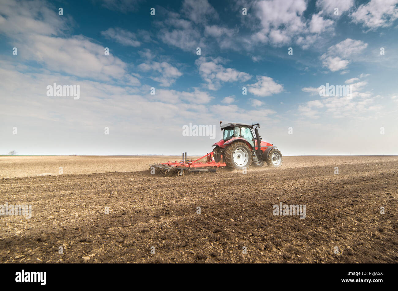 Tractor preparing land for sowing Stock Photo - Alamy