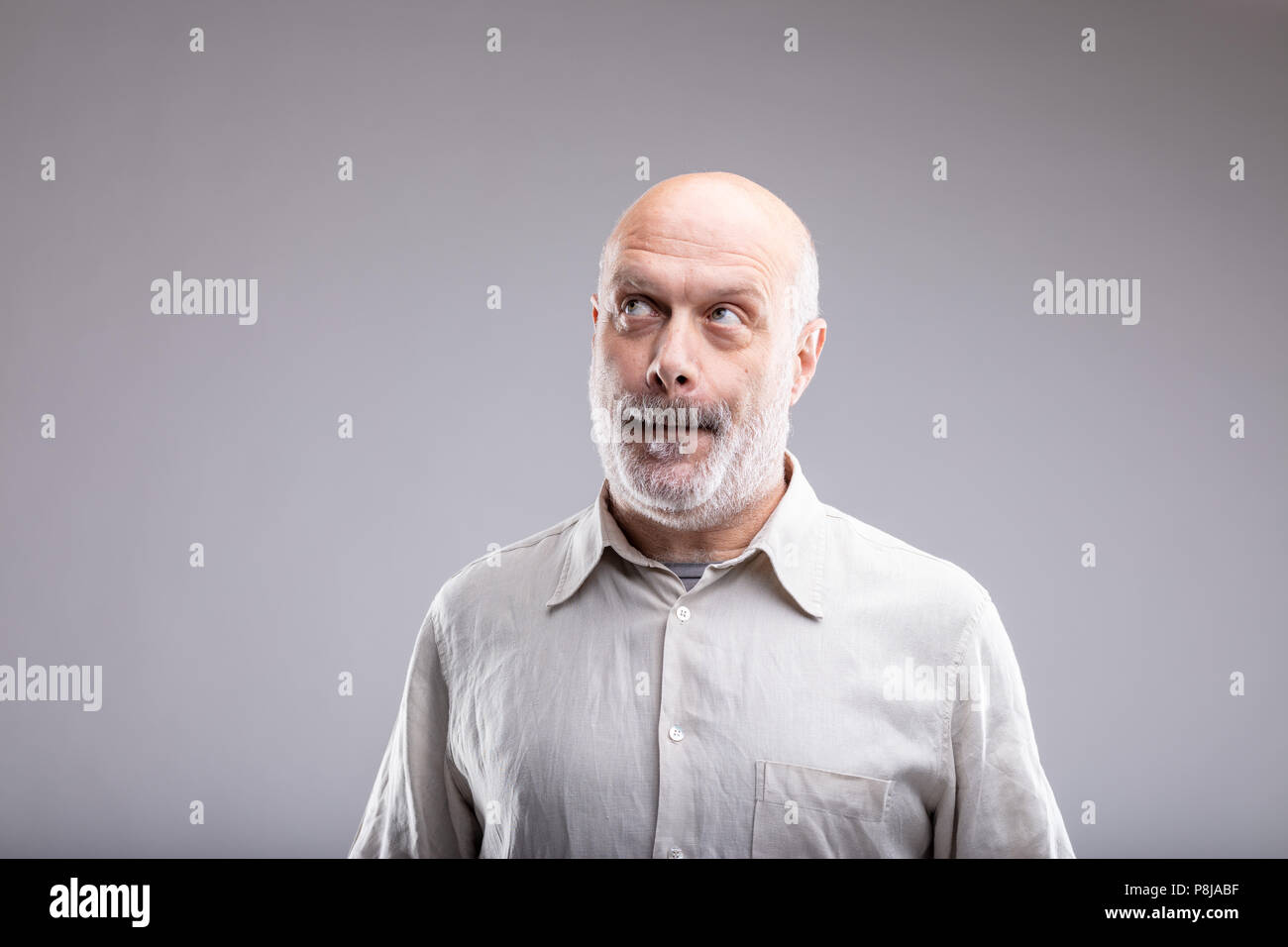 mature man looking guilty or having a smart idea Stock Photo - Alamy