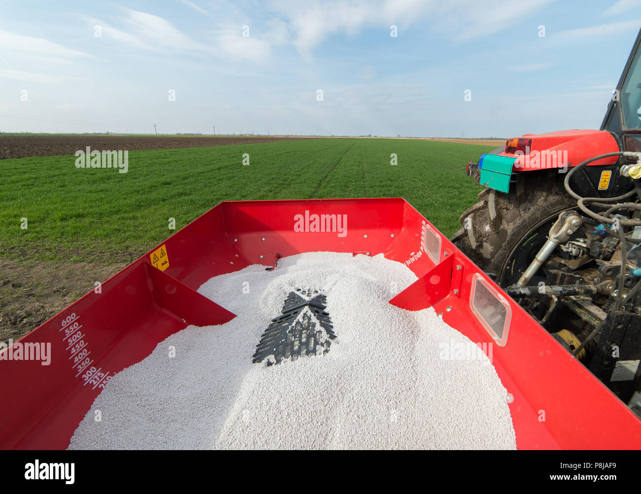 tractor fertilizing in wheat field Stock Photo - Alamy