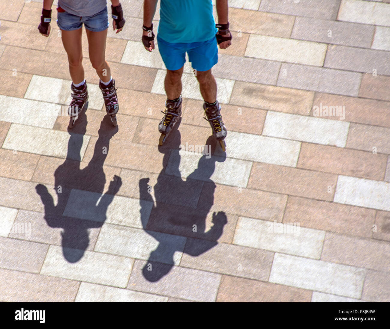 A shadow of a couple on roller skates Stock Photo - Alamy