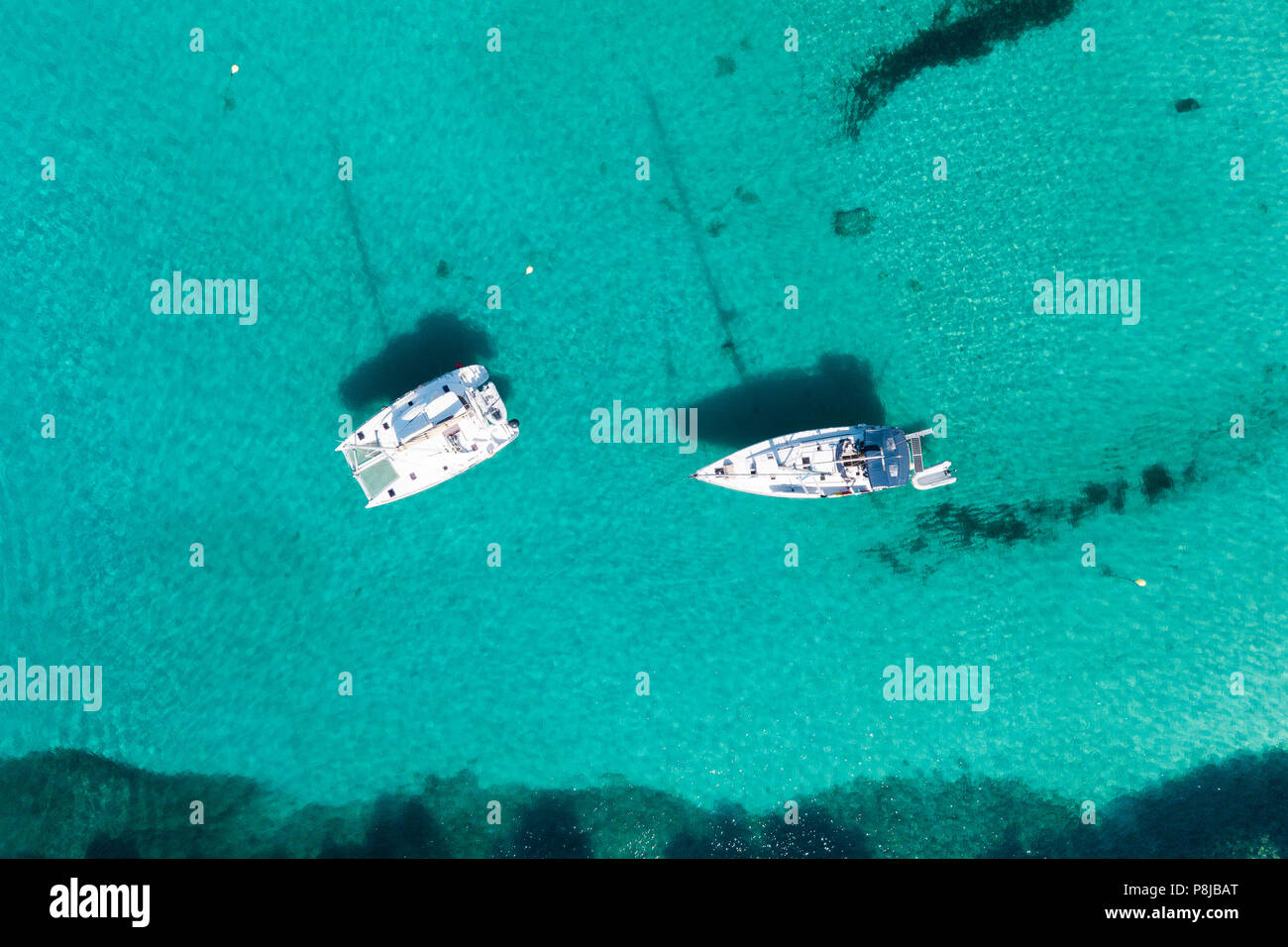 Aerial: Yachts in the azure water Stock Photo - Alamy