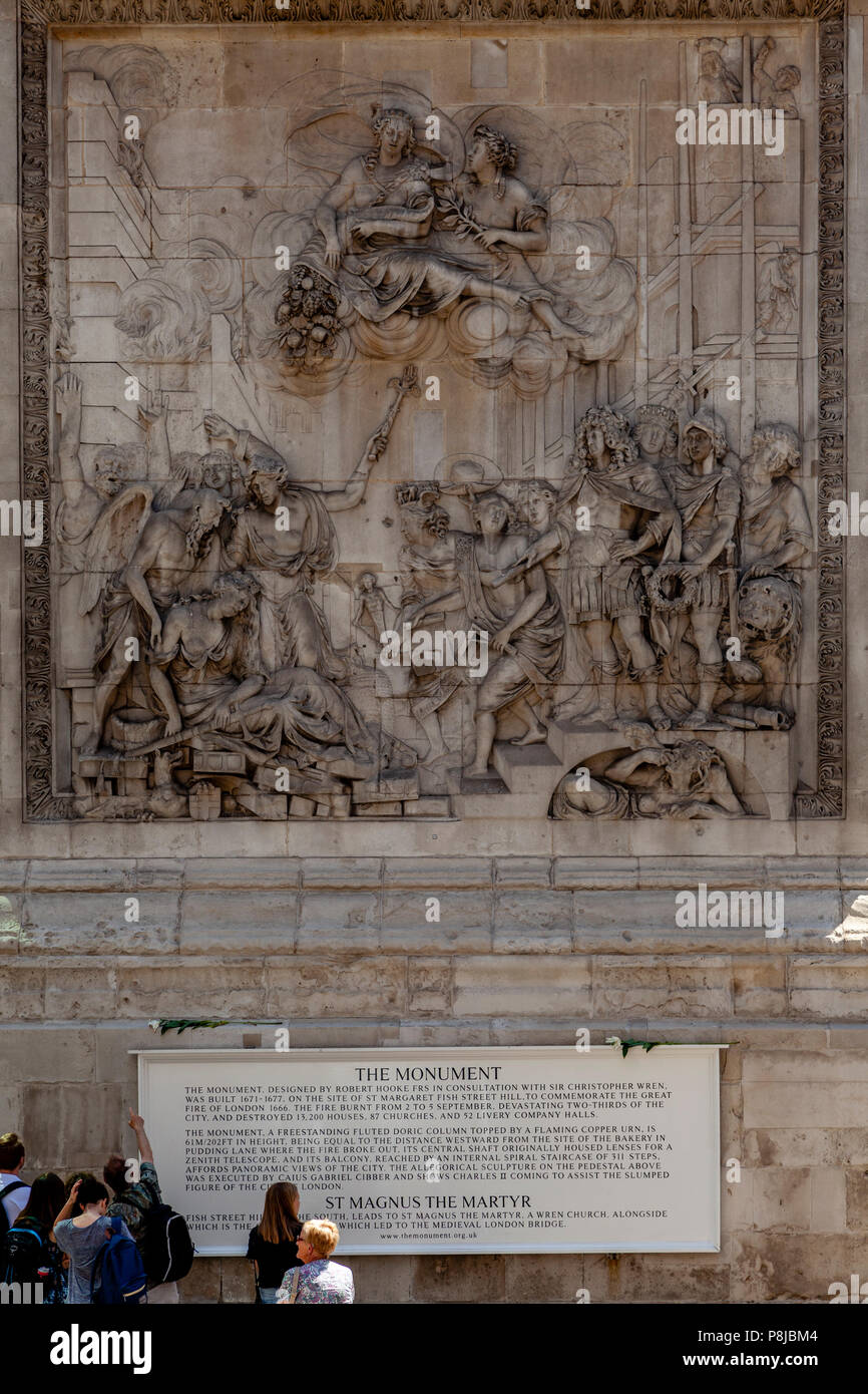 Tourists Looking At The Bas-Reliefs (Sculptures) At The Base Of The ...