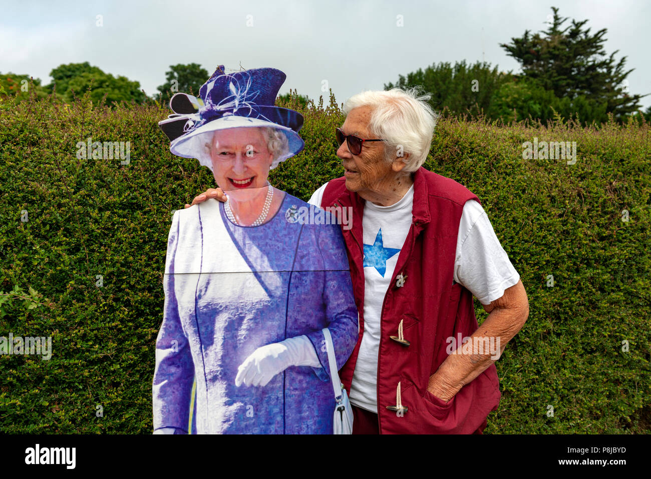 Royalist with a cardboard cutout Queen Elizabeth in her garden Stock ...