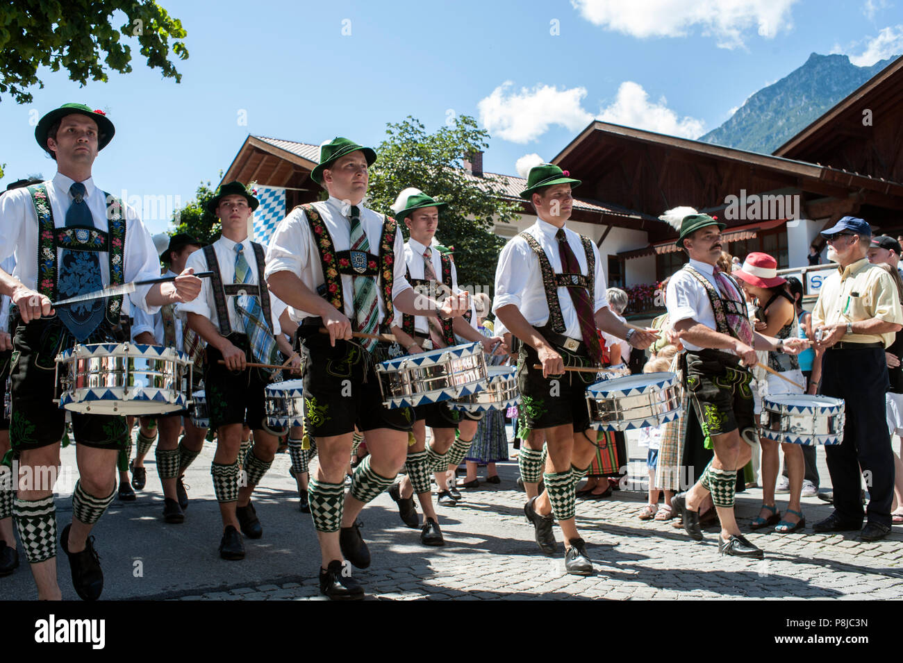Procession of a Bavarian brass band in the city of Garmisch ...
