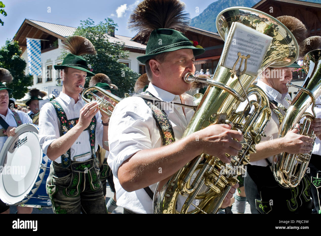 Procession of a Bavarian brass band in the city of Garmisch ...