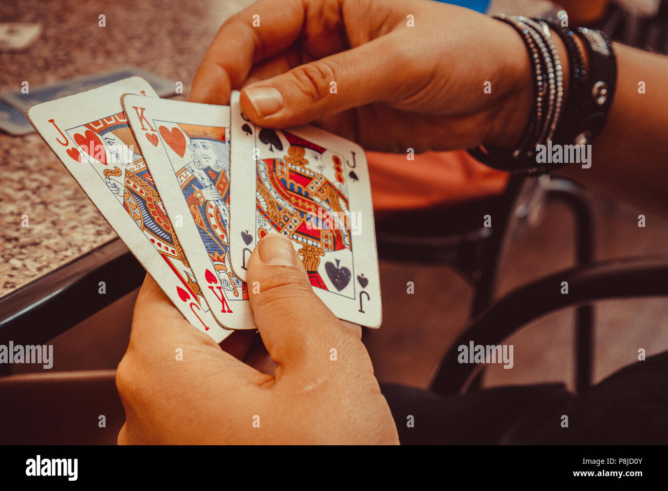 Hands using play cards Stock Photo - Alamy
