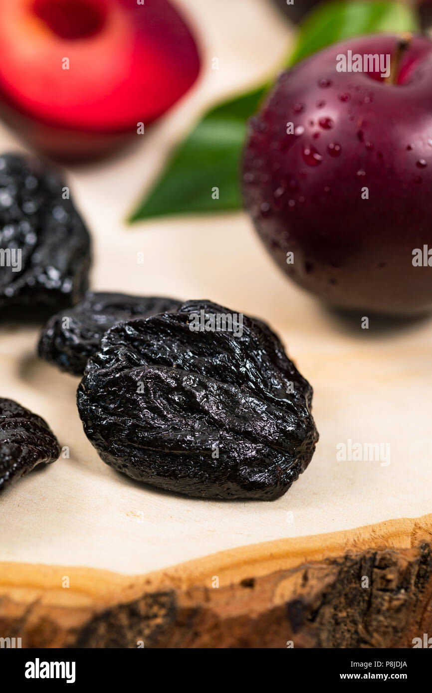 Dried Plums Pitted Prunes and Fresh Plums background Stock Photo - Alamy