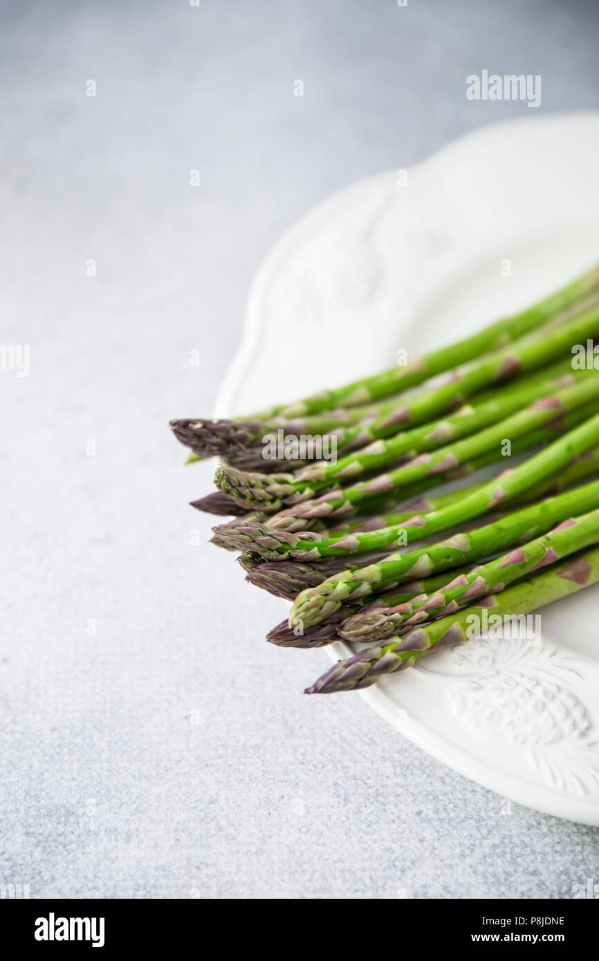 Fresh bunch of asparagus on white plate Stock Photo - Alamy
