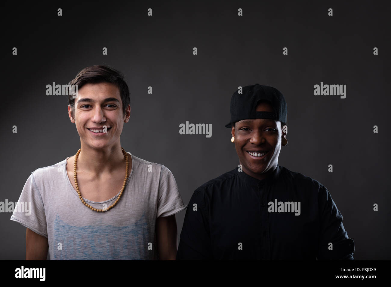 formal studio portrait of one white guy with his black friend in 2016 ...