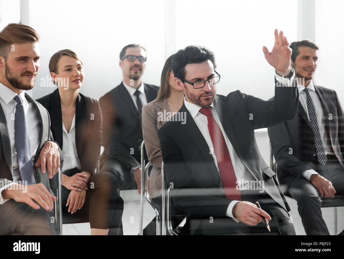 businessman raising his hand Stock Photo - Alamy