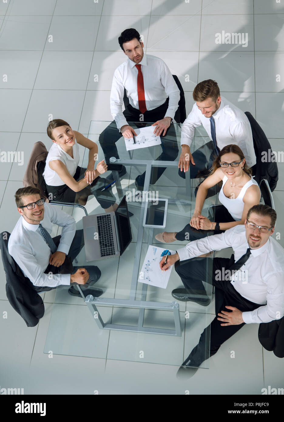 Business People Working Around a Conference Table Stock Photo - Alamy