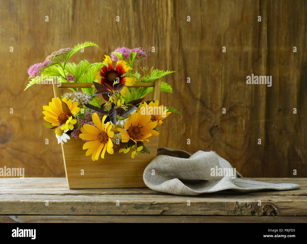 bouquet of wildflowers on a wooden background, rustic still life Stock ...