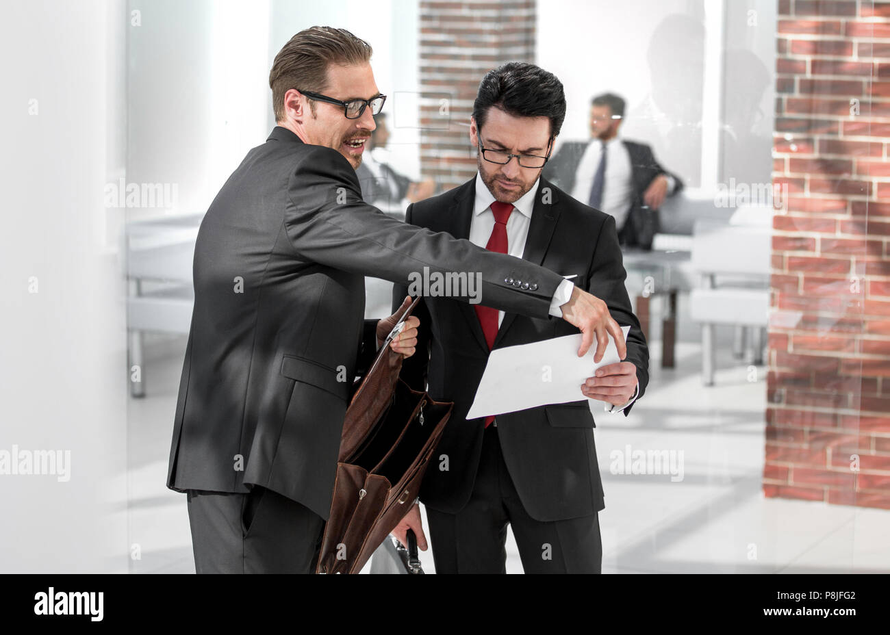business men with documents in a large conference room Stock Photo - Alamy