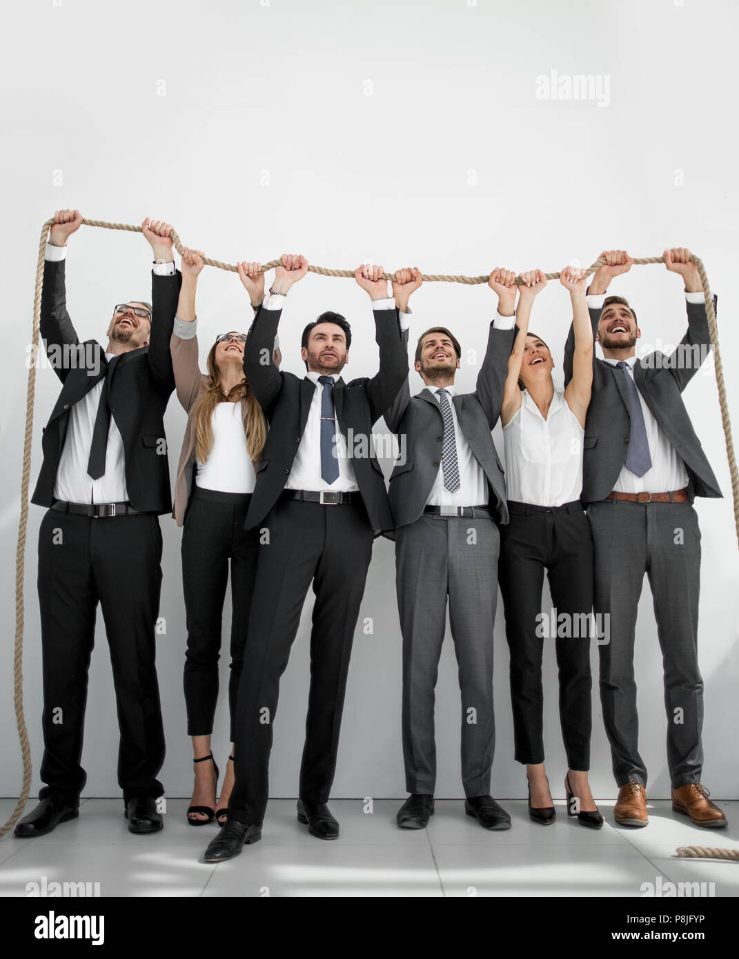business team holding strong rope Stock Photo - Alamy
