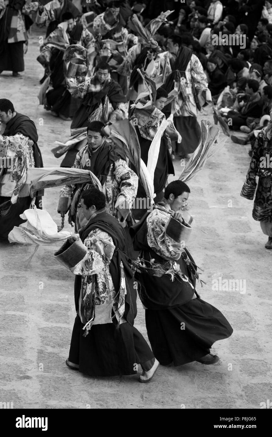 Monks dance with ribbons representing deity powers at the Monlam Chenmo ...