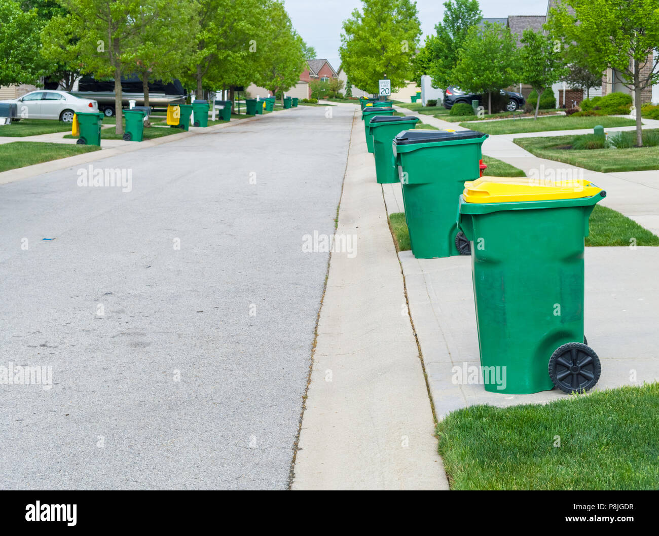 Row of garbage bins lined up along the roadside in a neat urban suburb ...