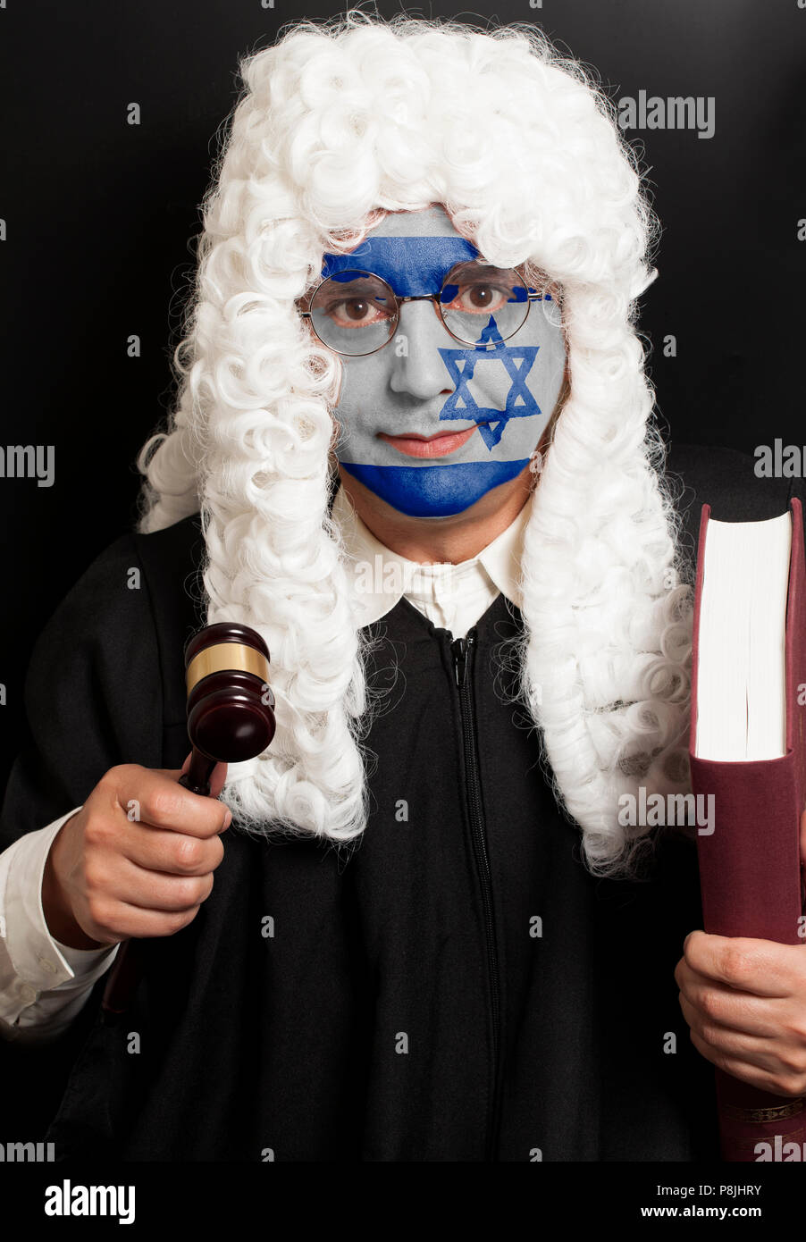 Portrait of male jewish lawyer with painted Israel flag holding judge ...
