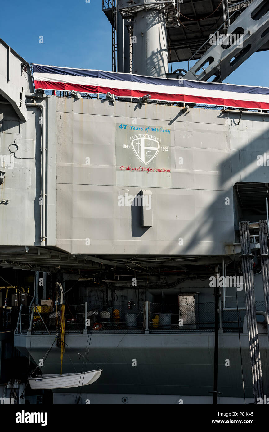 port-side view of USS Midway from the pier showing bunting, signage ...