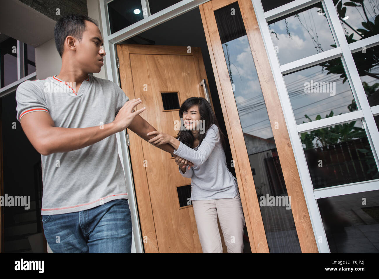 Man walking out of door during argument with his woman. couple having ...