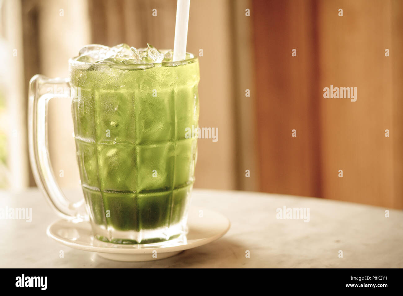 Green Cordial Syrup In Clear Glass On Table Stock Photo - Alamy