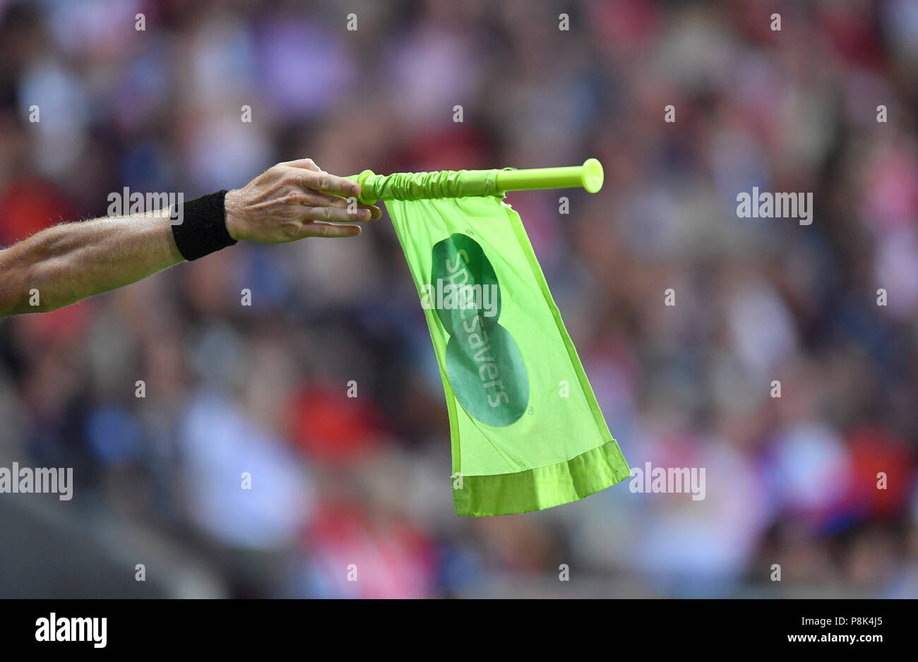 Detail of a linesman holding a flag Stock Photo - Alamy